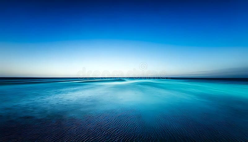 A Blue Gradient Sky Meets the Textured Waters of a Serene Ocean Stock ...