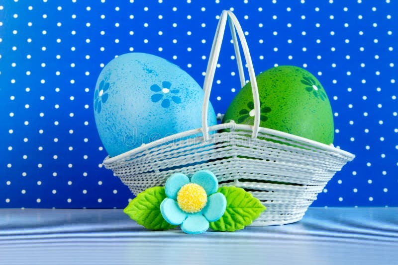 Blue and Green Easter Eggs in a Basket with White Flower Stock Image ...