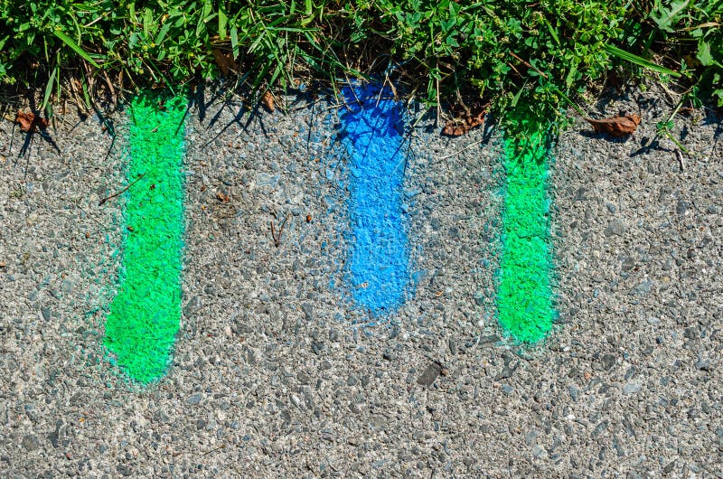 Blue and Green Environmental Utility Markings on a Sidewalk in the ...
