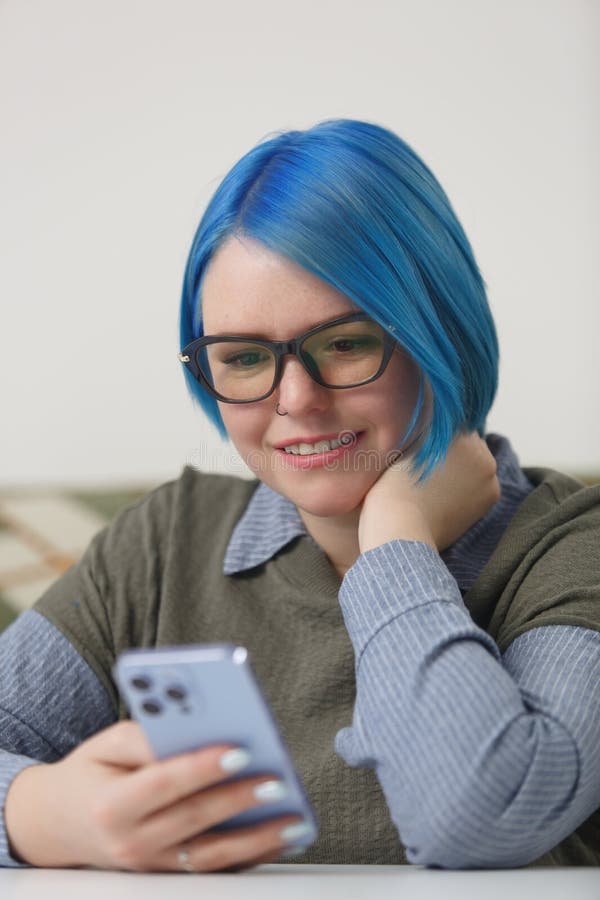Blue Haired Woman in Glasses Browsing Mobile App on Modern Smart Phone ...