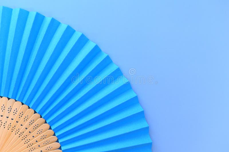A Blue Hand Fan on a Blue Background. Chinese, Japanese, Asian ...