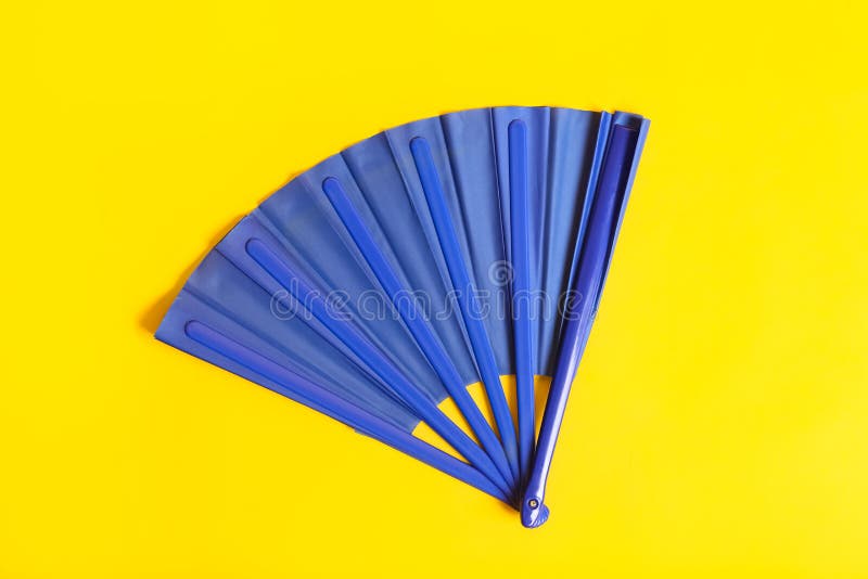 Blue Hand Fan on Yellow Background, Top View Stock Image - Image of ...