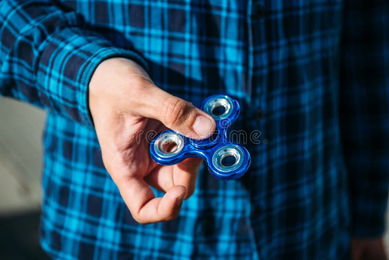 Blue Hand Spinner on Blue Background Stock Photo - Image of human ...