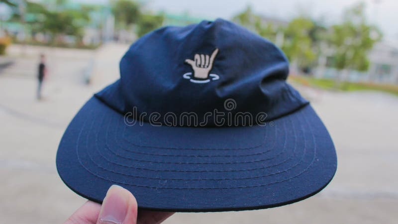 A Blue Hat with a Hand Logo on it Editorial Image - Image of skuy ...