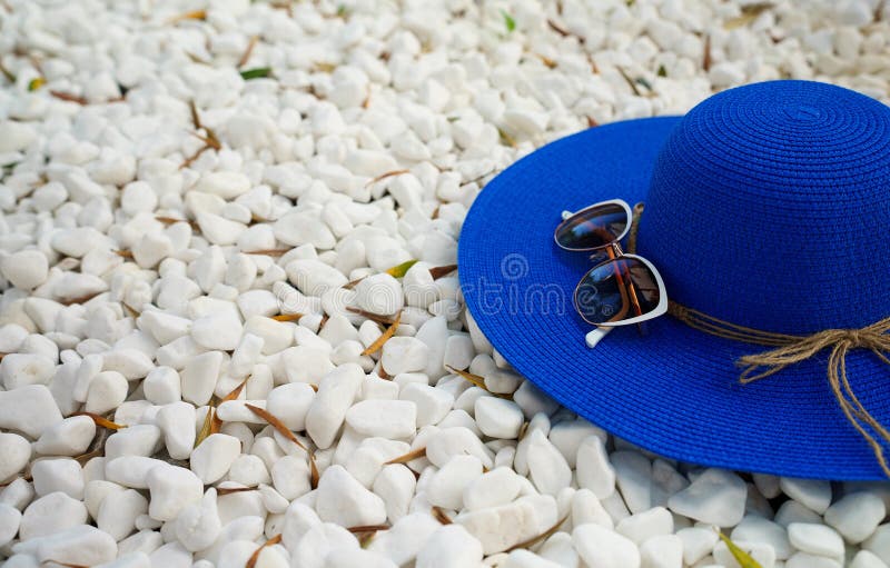 Blue Hat with Sunglasses Lies on the Rocks Stock Image - Image of ...
