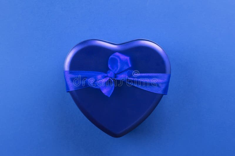 Blue Heart-shaped Box with Ribbon on Blue Background Stock Photo ...