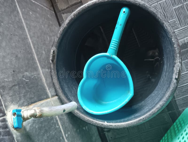 A Blue Heart-shaped Dipper and a Black Bucket Stock Image - Image of ...