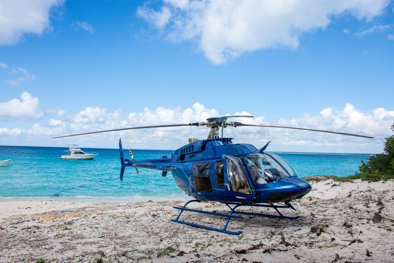 Blue Helicopter on the Beach on Tree and Beautiful Ocean and Clouds at ...