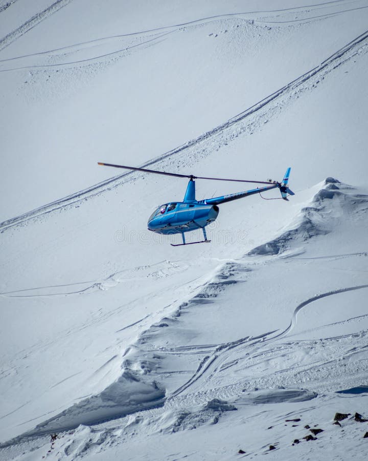 Blue Helicopter Flies Over the Snow in the Mountains Editorial ...