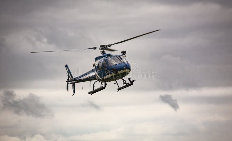 Blue Helicopter in Flight Over Gray Sky Stock Image - Image of travel ...