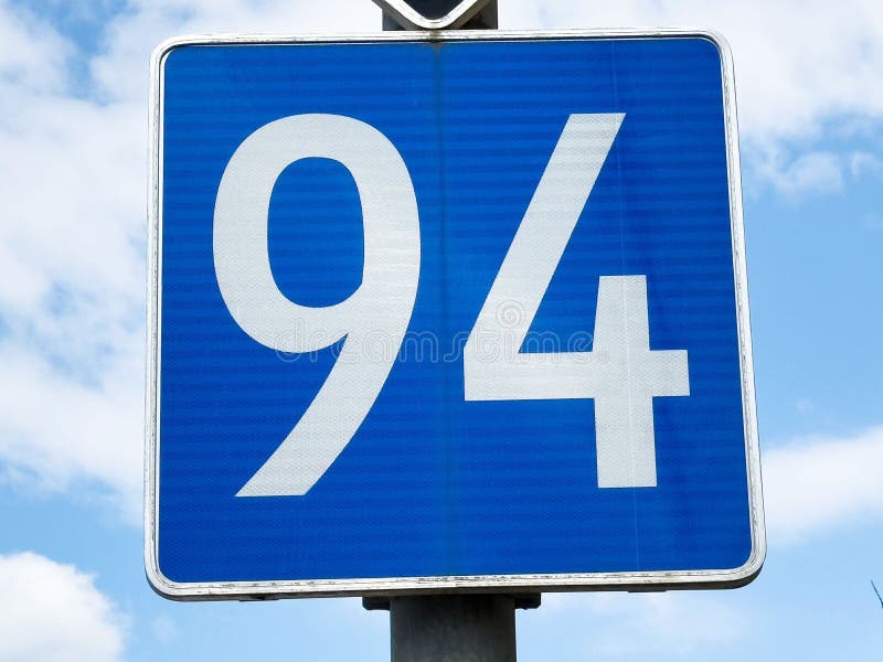 Blue Highway Sign with Number 94 Against a Cloudy Sky Background Stock ...