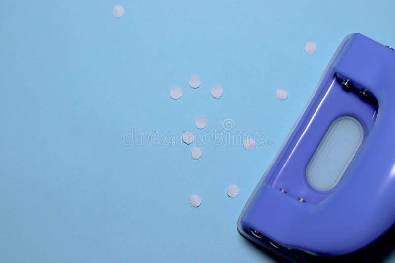 Blue Hole Punch or Perforate Machine on Sky Blue Background Stock Photo ...