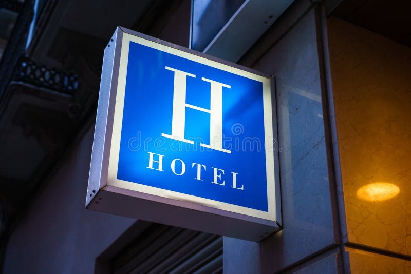 Blue hotel sign on wall stock photo. Image of white - 201669154