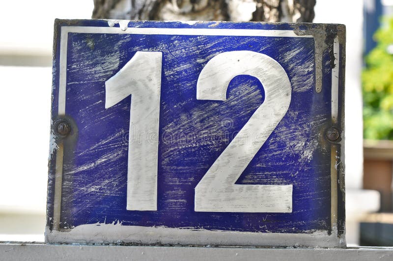 A Blue House Number Plaque, Showing the Number Twelve Stock Image ...