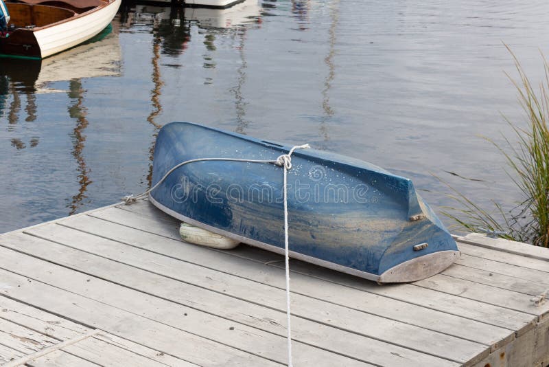 Blue Hull of a Small Boat, Upside Down, Lashed Down To the Top of a ...