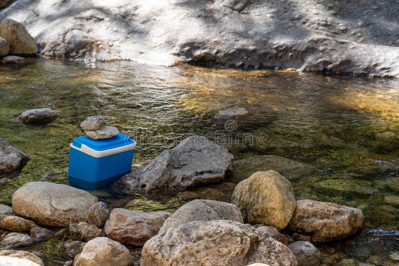 Blue Ice Box Cooler Placed on Water of a Rocky River Stock Photo ...