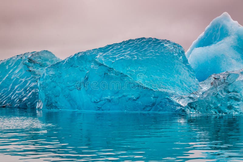 Iceberg Flipping Over during Stormy Weather Stock Photo - Image of ...