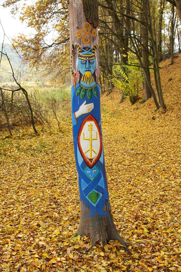 Blue Idol on the Tree Trunk Stock Photo - Image of clothes, heathen ...
