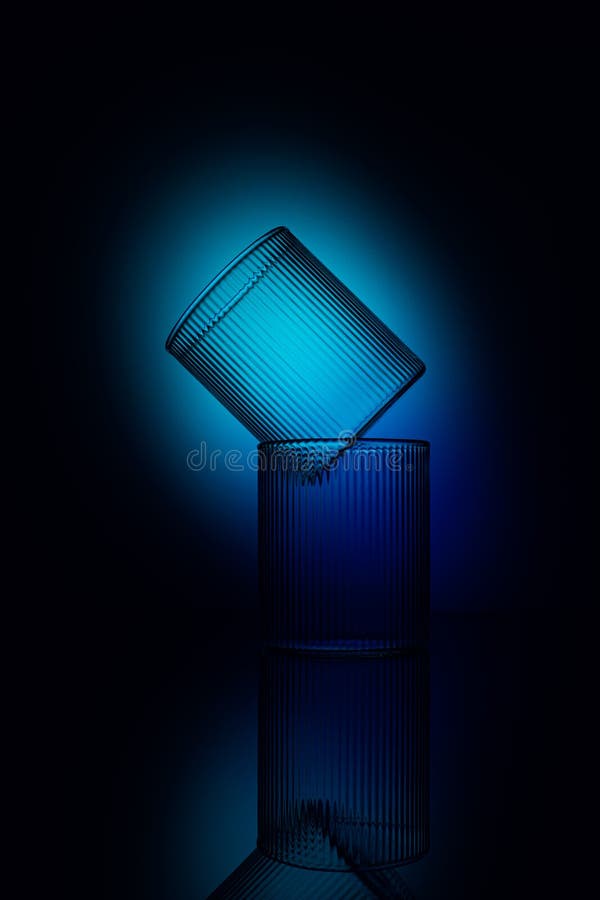 Blue Illuminated Glassware, Dark Backdrop, Reflective Surface Stock ...