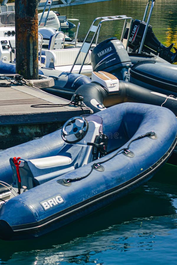 Blue Inflatable Boat Stands on a Dock in a Vertical Shot in Close ...