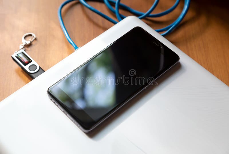 Blue Internet Cable, Flash Card and Smartphone Laying on the White ...