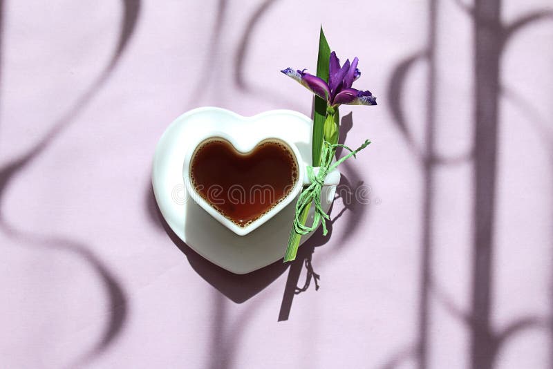 Blue Iris Flower with a Cup of Tea in the Shape of a Heart on a Pastel ...