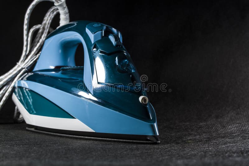 The Blue Iron for Ironing of Clothes. Monophonic Black Background ...