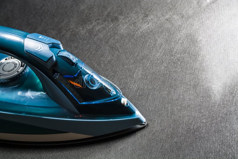 The Blue Iron for Ironing of Clothes. Monophonic Black Background ...