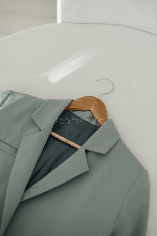 Blue Jacket on a White Sofa Stock Image - Image of clothing, blue ...