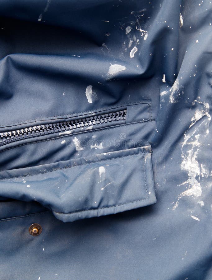 A Blue Jacket with a Zipper Pocket and a White Paint Stain on it Stock ...