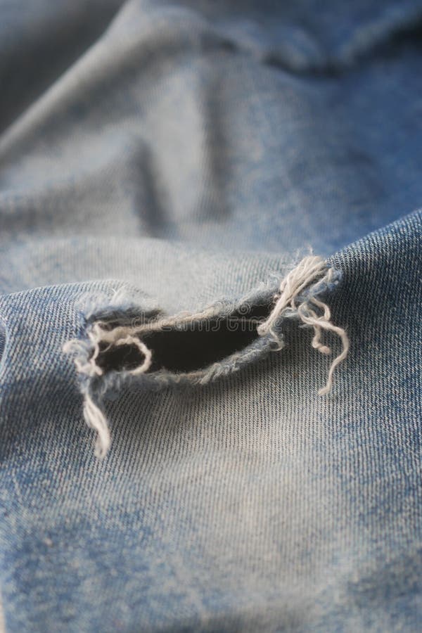 Blue Jean Texture with a Hole and Ripped Threads Showing Stock Image ...