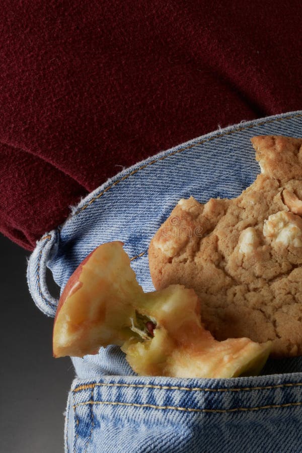 Apple Core and Cookie Stuffed into Pants Pocket Stock Image - Image of ...