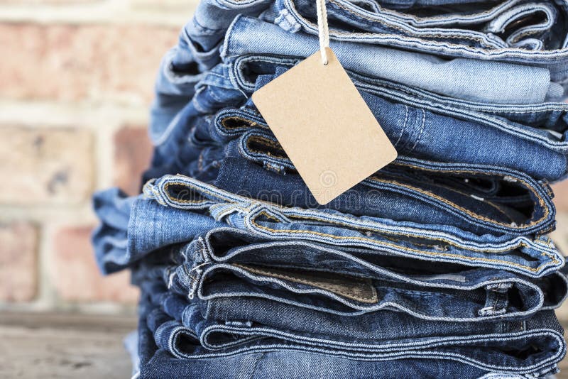 Blue Jeans with Tag on Brick Background Stock Image - Image of brick ...