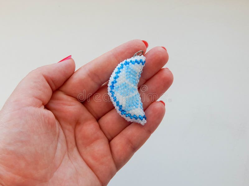 Blue keychain lies in hand stock image. Image of ornament - 370651763