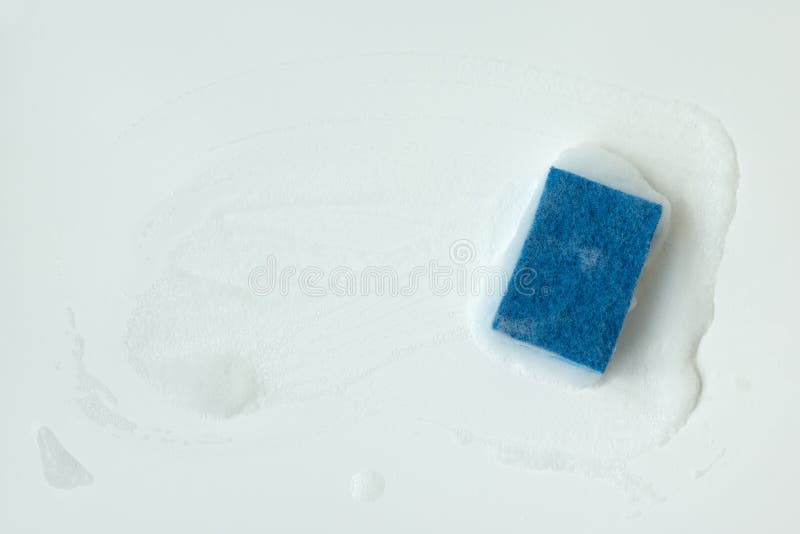 Blue Kitchen Cleaning Sponge with Soap Bubbles on Blue Background ...
