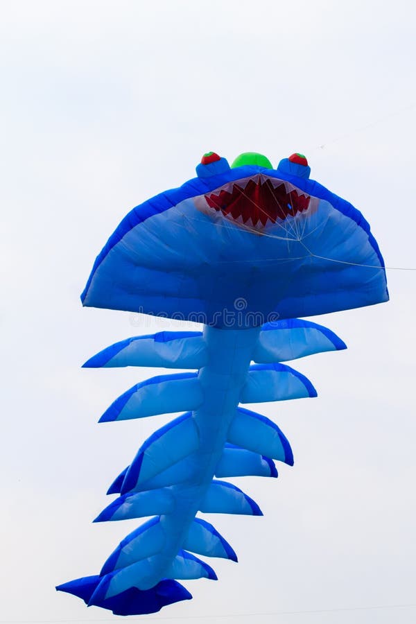 Blue kite that is flying stock image. Image of wires - 103033677