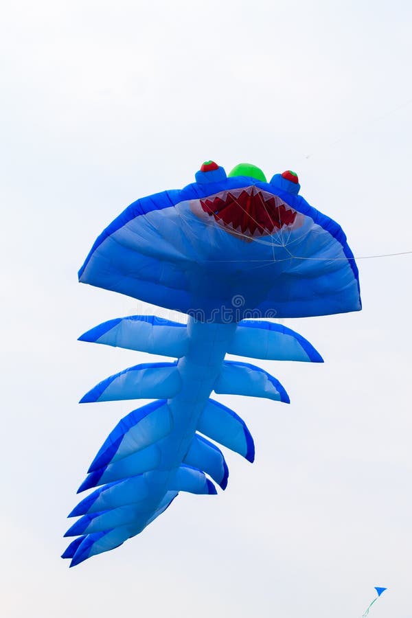 Blue kite that is flying stock image. Image of mouth - 91465067