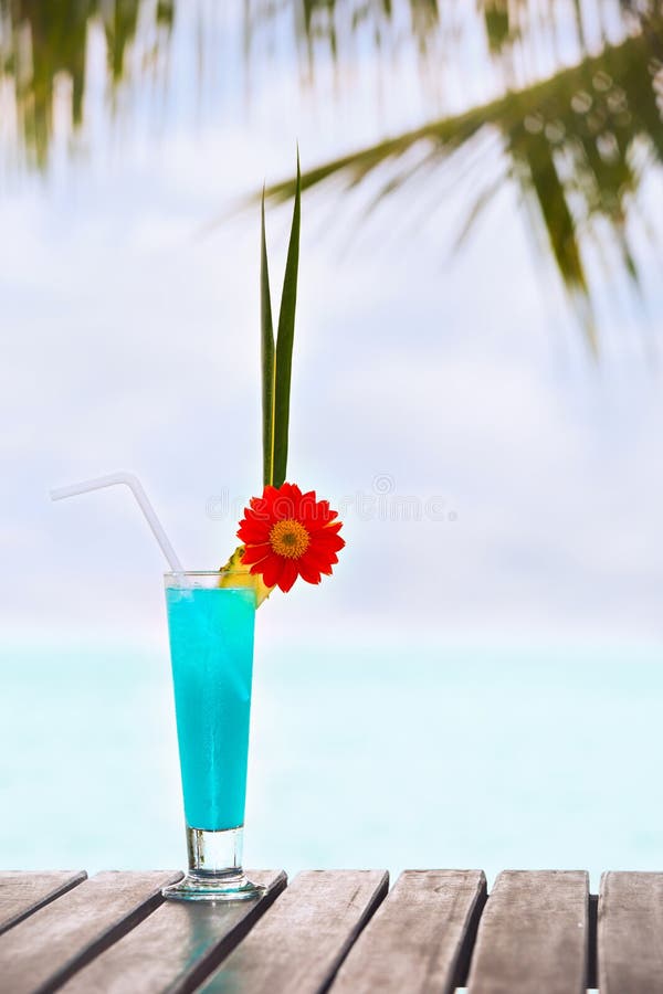 Blue Lagoon Cocktail on the Table at Tropical Beach Stock Photo - Image ...