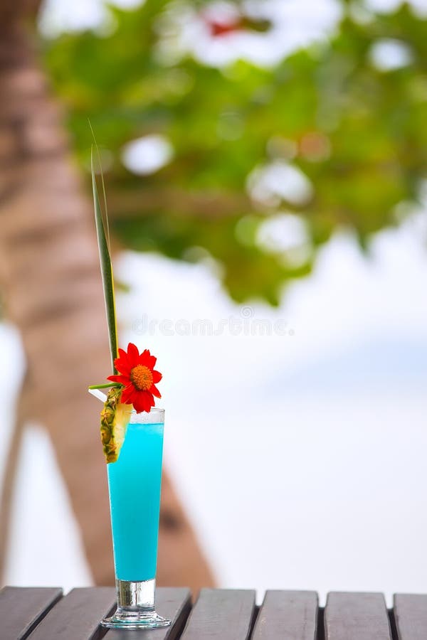 Blue Lagoon Cocktail on the Table at Tropical Beach Stock Photo - Image ...