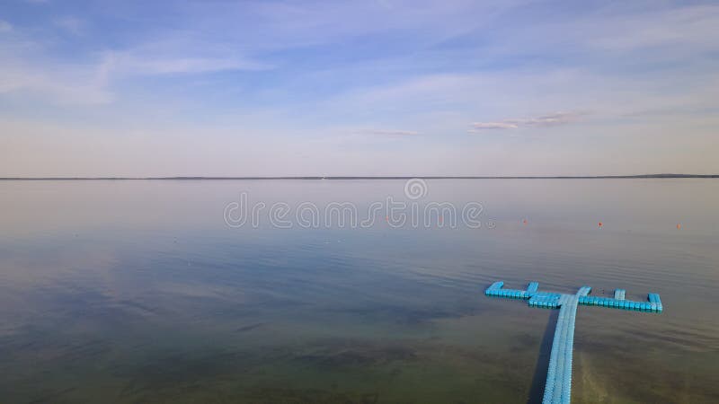 Blue Lake, Blue Sky and Blue Plastic Pier. Small Dock for Boat and Ship ...
