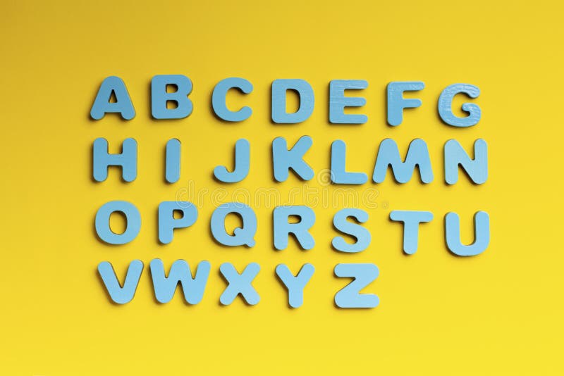 Blue Letters on a Yellow Background Stock Photo - Image of abstract ...