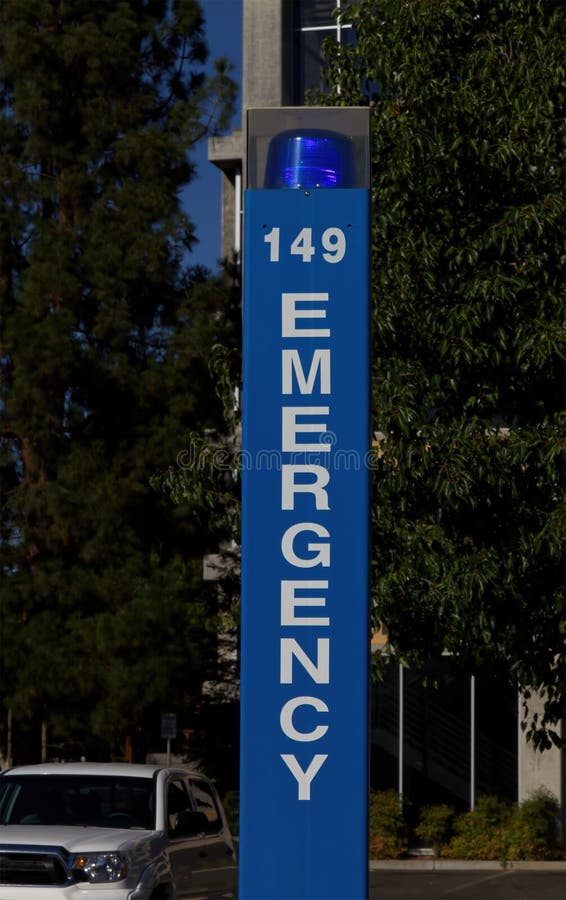 Blue Light Emergency Call Box Sign with Green Trees Stock Image - Image ...