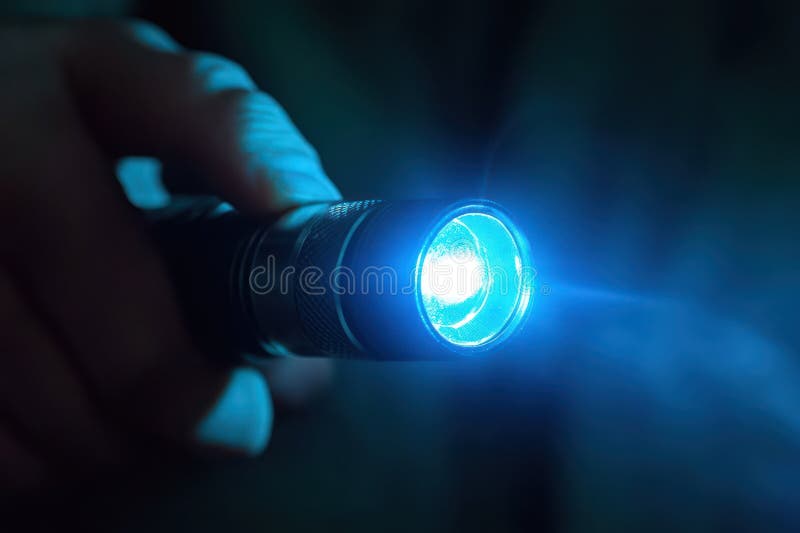 Blue Light Flashlight in Hands Against Black Background Stock Photo ...