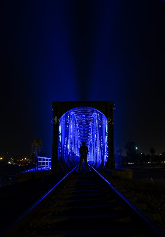 Blue Light Illuminated Train Bridge and a Man Stock Image - Image of ...