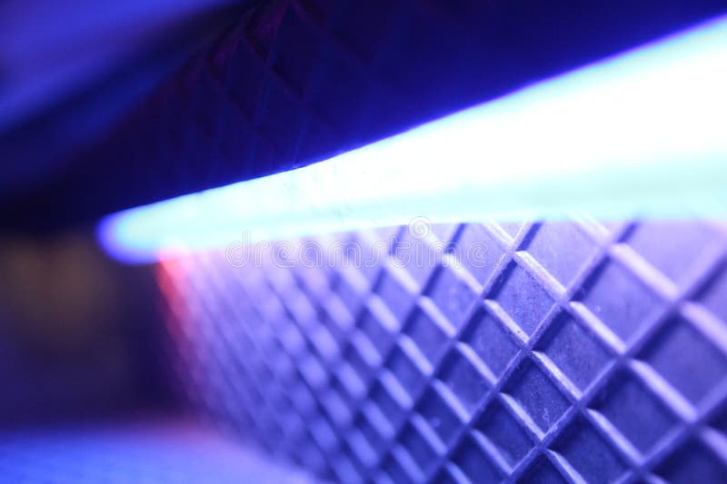 A Blue Light is Shining on a Wall with a Pattern of Squares Stock Photo ...