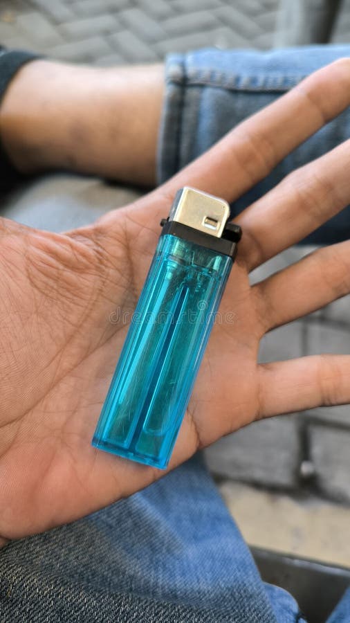 Blue Lighter on Open Hand stock image. Image of hand - 317234257