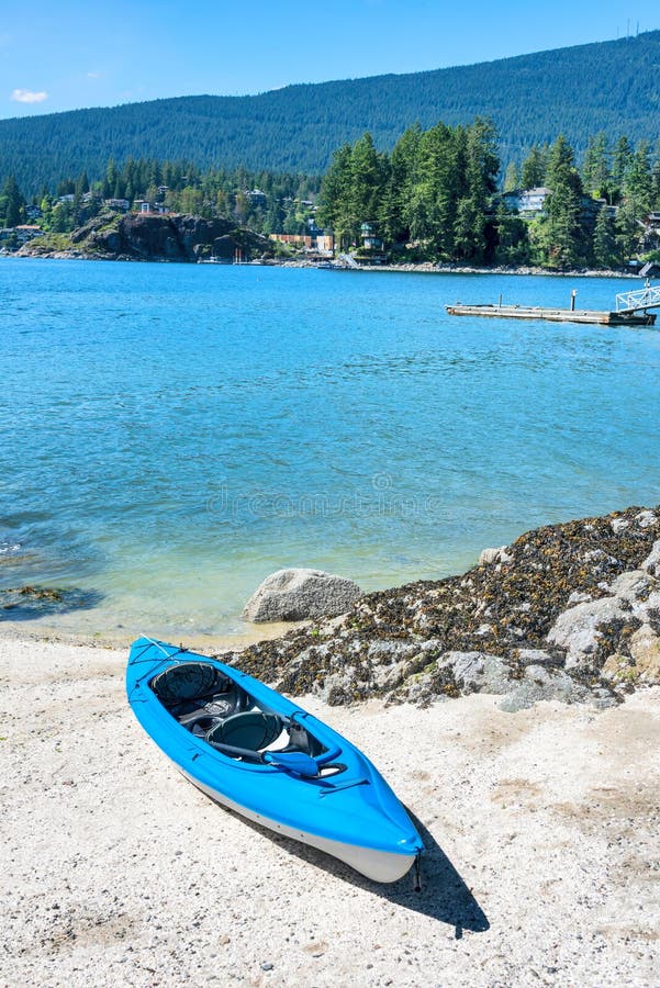 Blue Lightweight Canoe Boat on a Shore of Pacific Ocean Bay on Sunny ...