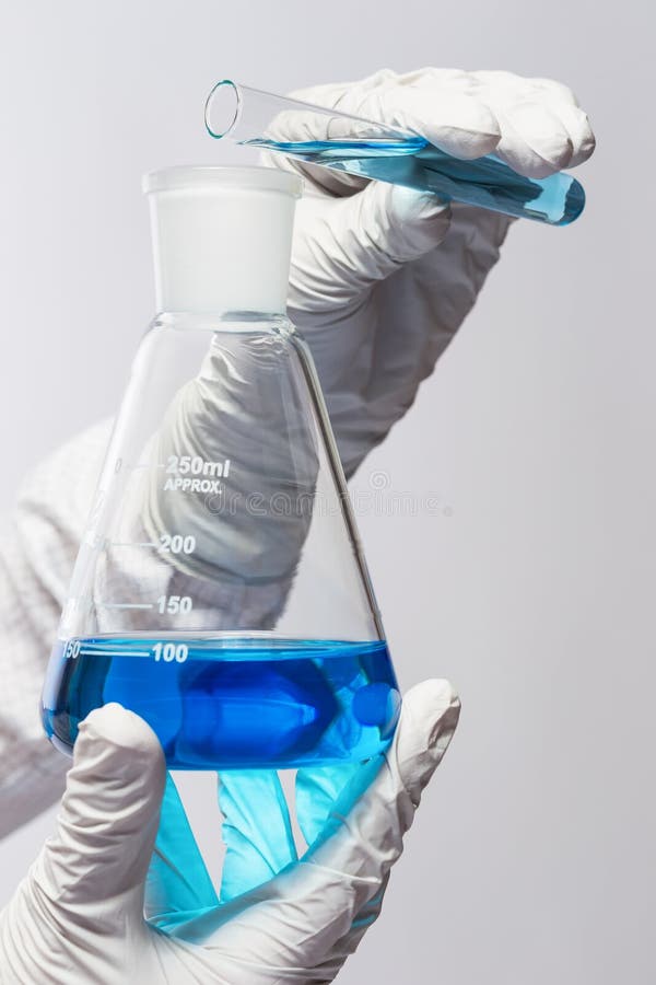 Blue Liquid in Different Containers in the Hands of the Scientist Stock ...