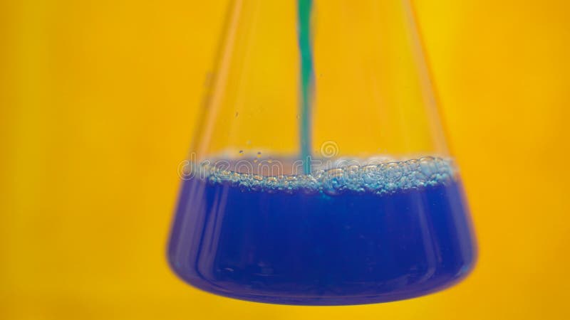Blue Liquid Poured into the Erlenmeyer. the Liquid Flows into the Glass ...