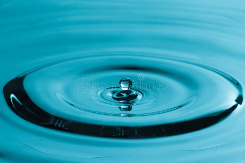 Perfect Water Drop Splashing into Smooth Water Causing Ripples Stock ...